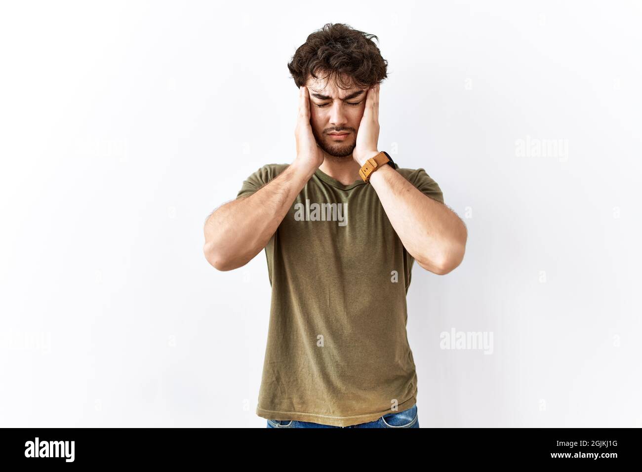 Hispanic man standing over isolated white background with hand on head ...