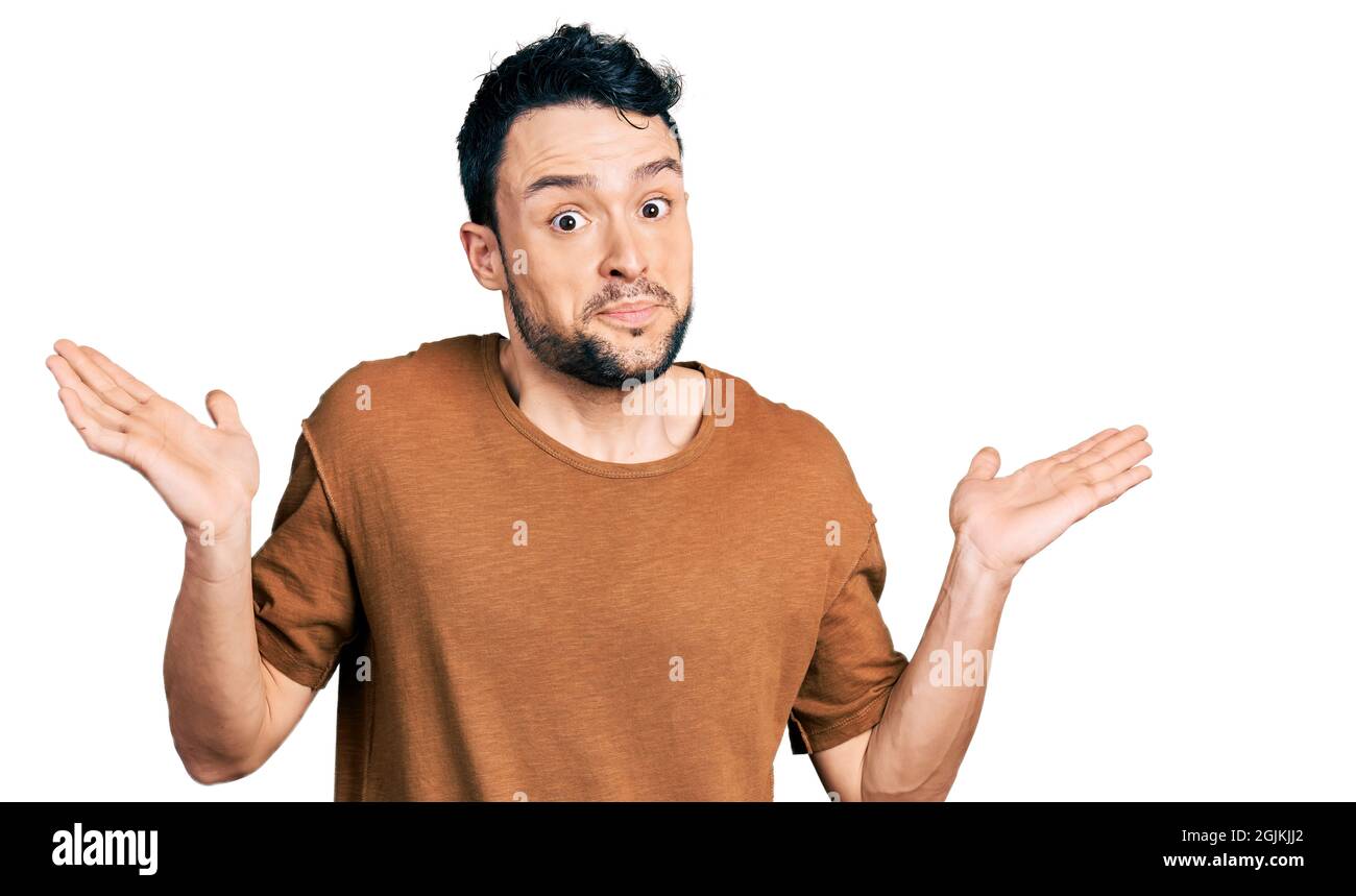 Hispanic man with beard wearing casual t shirt clueless and confused ...