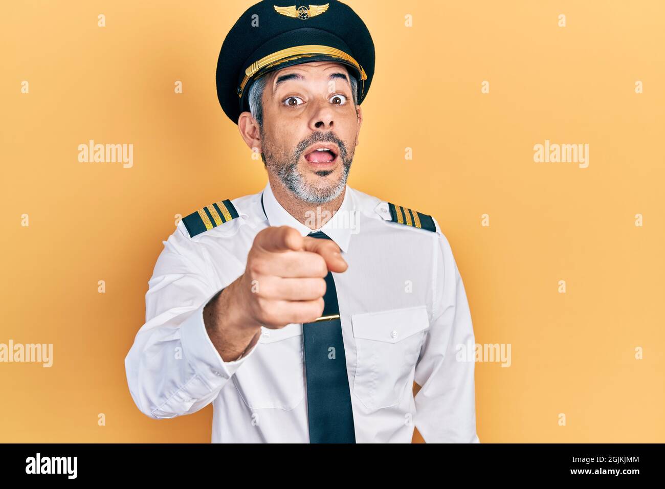 Handsome middle age man with grey hair wearing airplane pilot uniform ...
