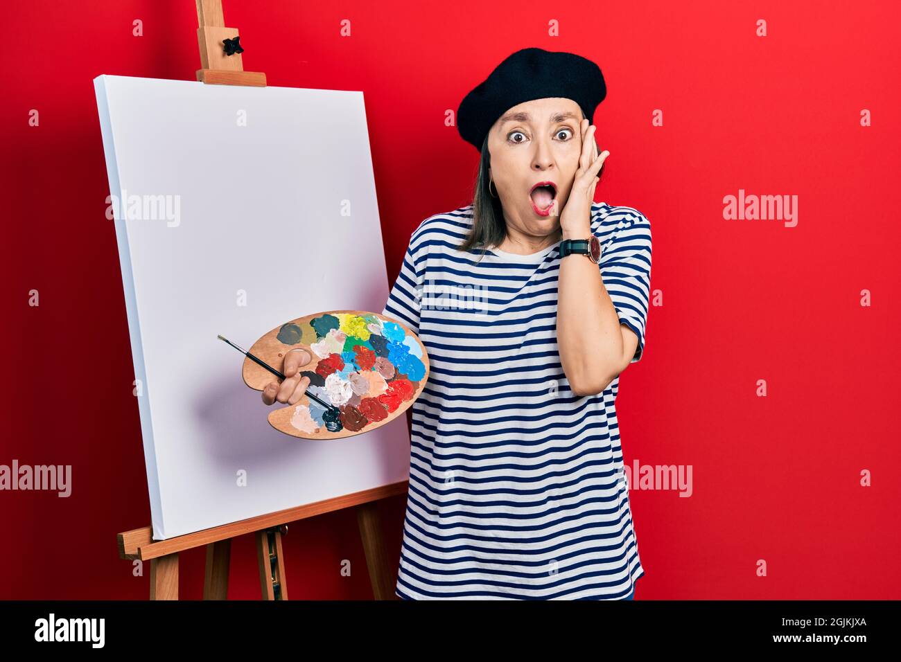 Middle age hispanic woman standing drawing with palette by painter ...