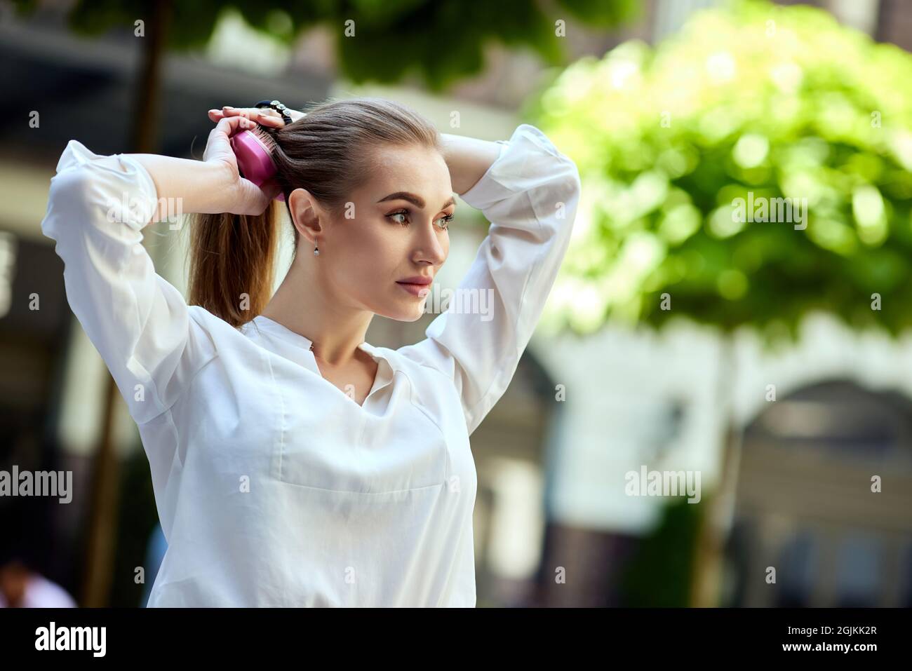 beautiful woman combs long hair with brush Stock Photo - Alamy
