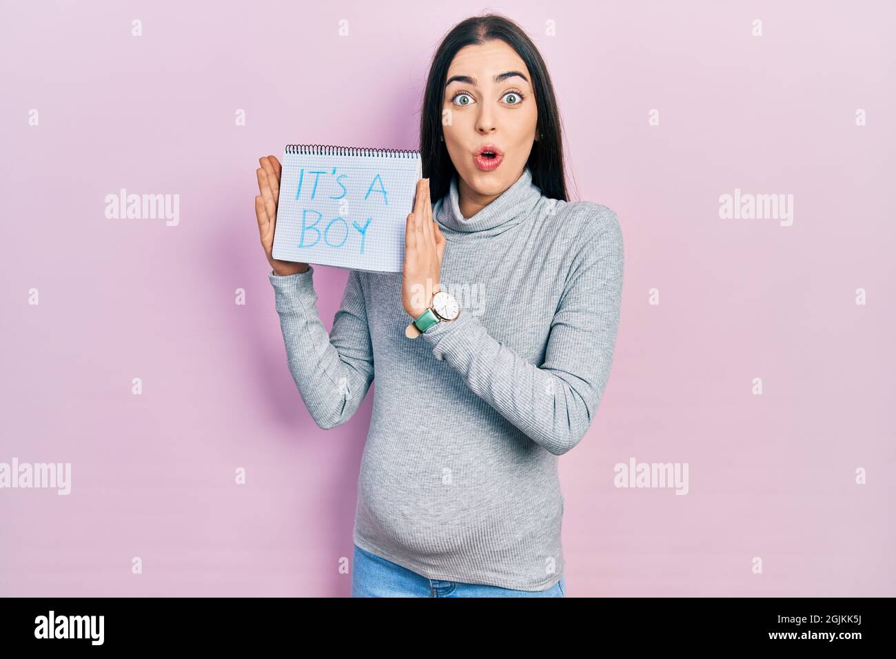 Beautiful woman with blue eyes expecting a baby holding its a boy ...
