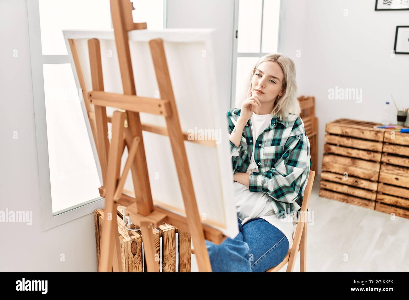 Young artist student girl concentrated looking canvas at art studio ...