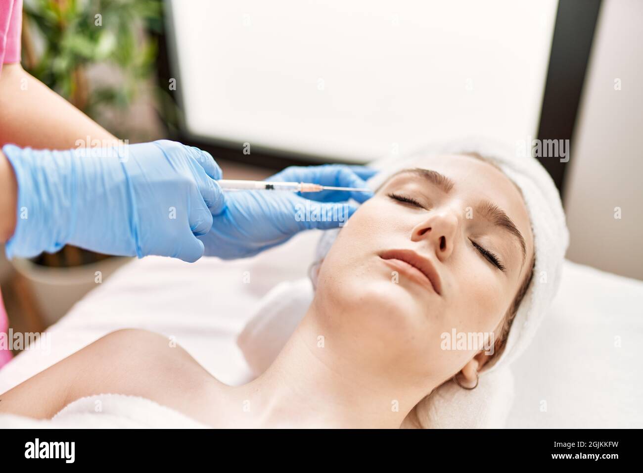 Doctor injecting botox on woman face for anti aging treatment at the ...