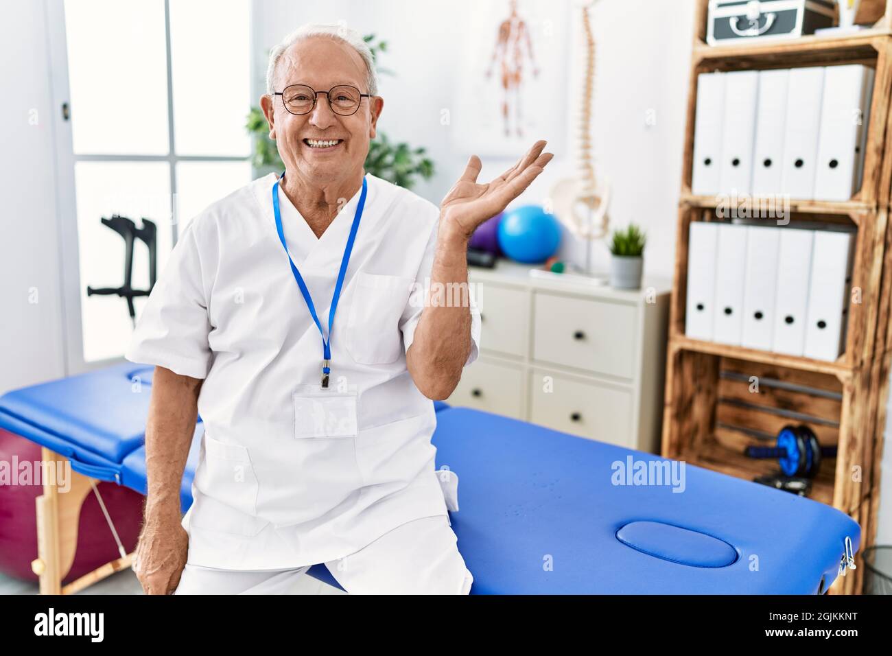 Senior physiotherapy man working at pain recovery clinic smiling ...