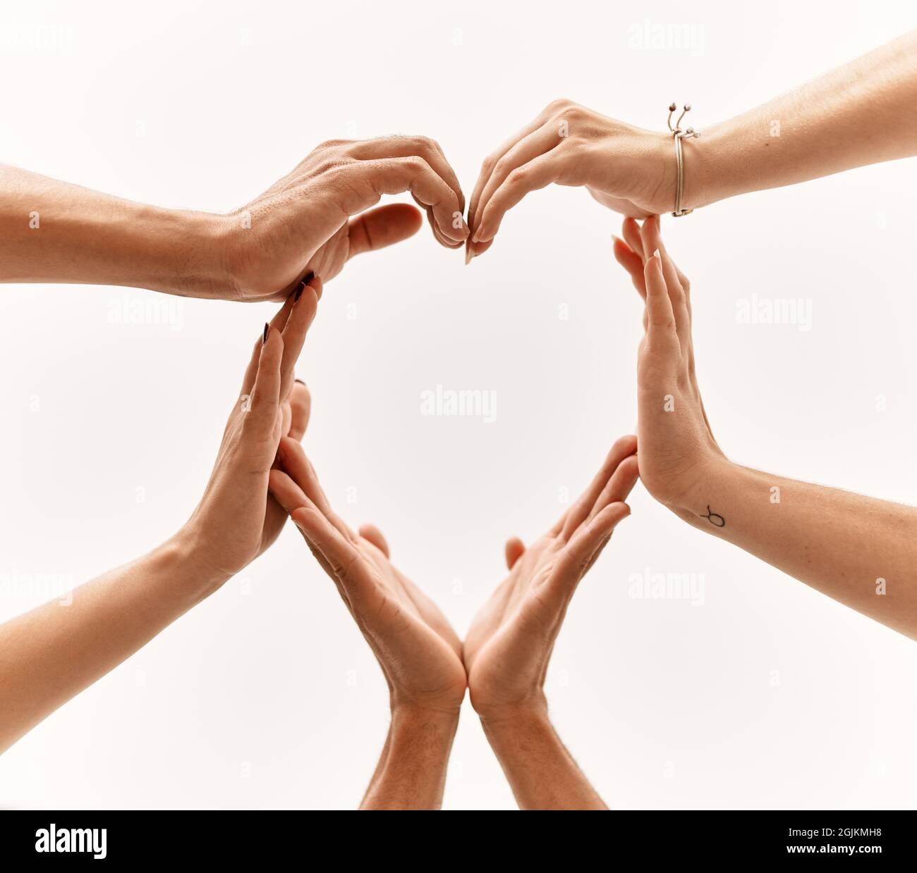 Group of young friends with hands together doing heart symbol Stock ...