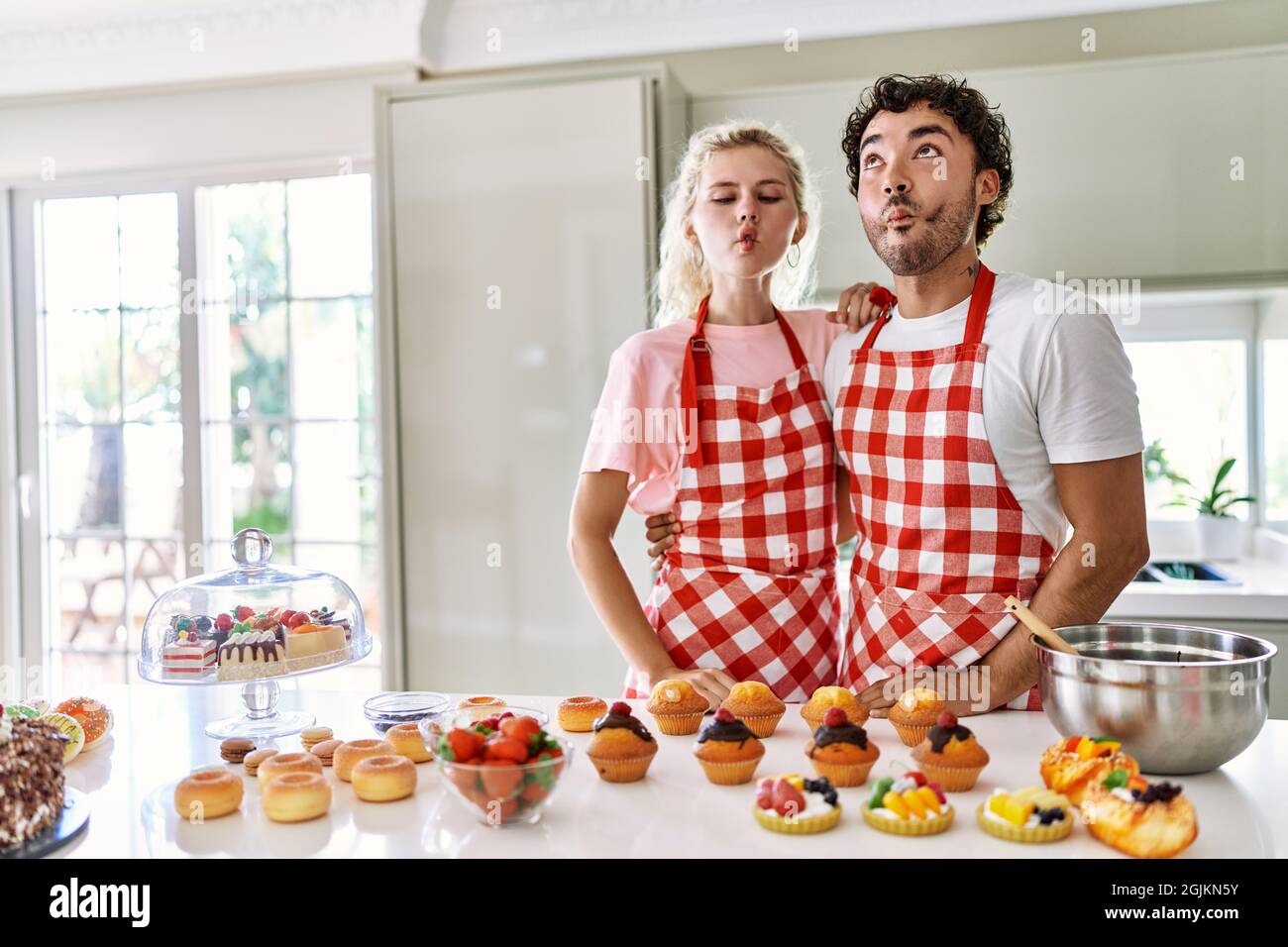 Couple of wife and husband cooking pastries at the kitchen making fish ...