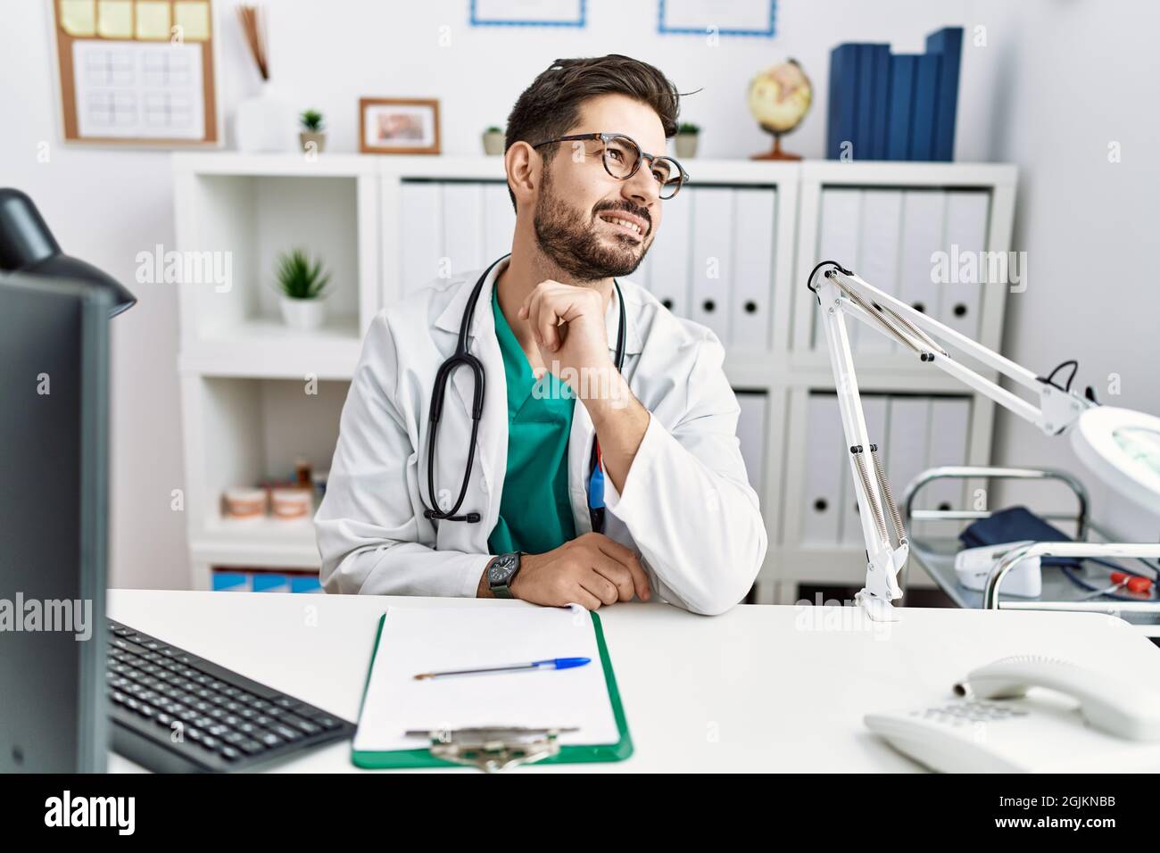 Young man with beard wearing doctor uniform and stethoscope at the ...