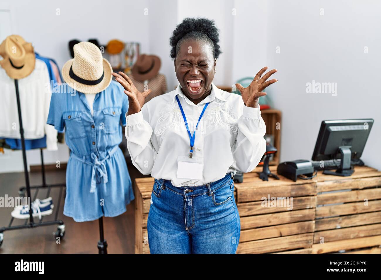 Young african woman working as manager at retail boutique celebrating ...