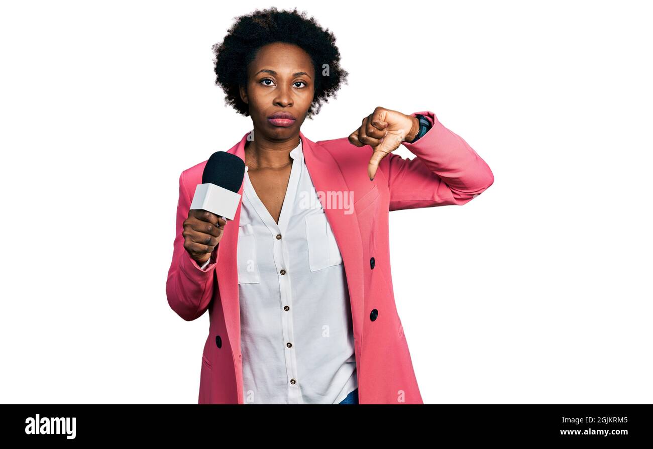 African american woman with afro hair holding reporter microphone with ...