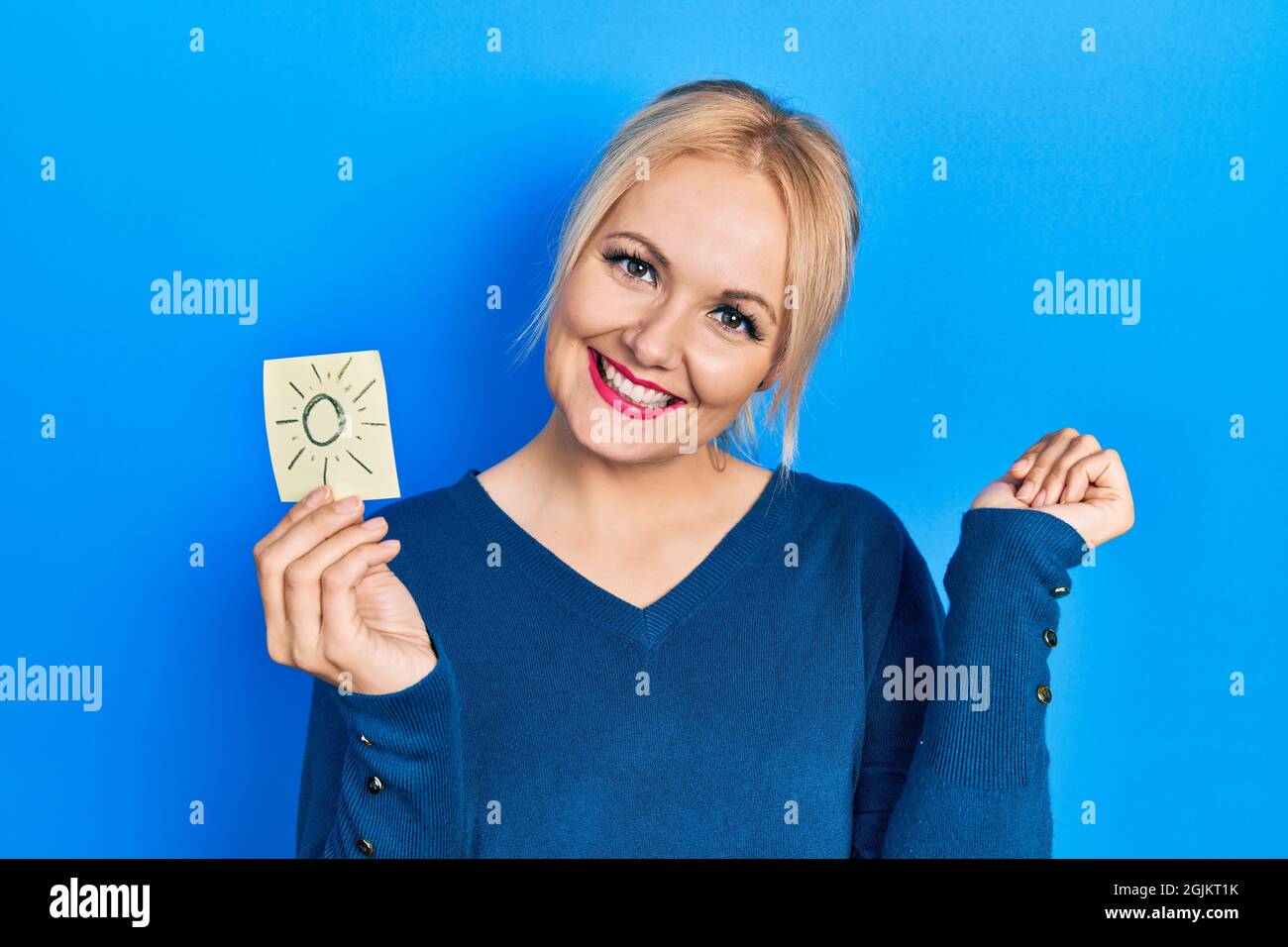 Young blonde woman holding sun draw reminder screaming proud ...