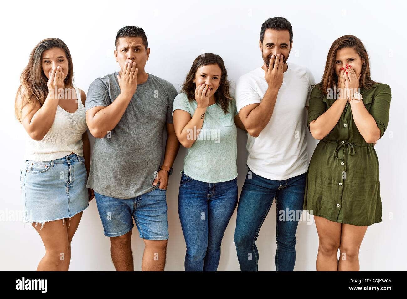 Group of young hispanic friends standing together over isolated ...