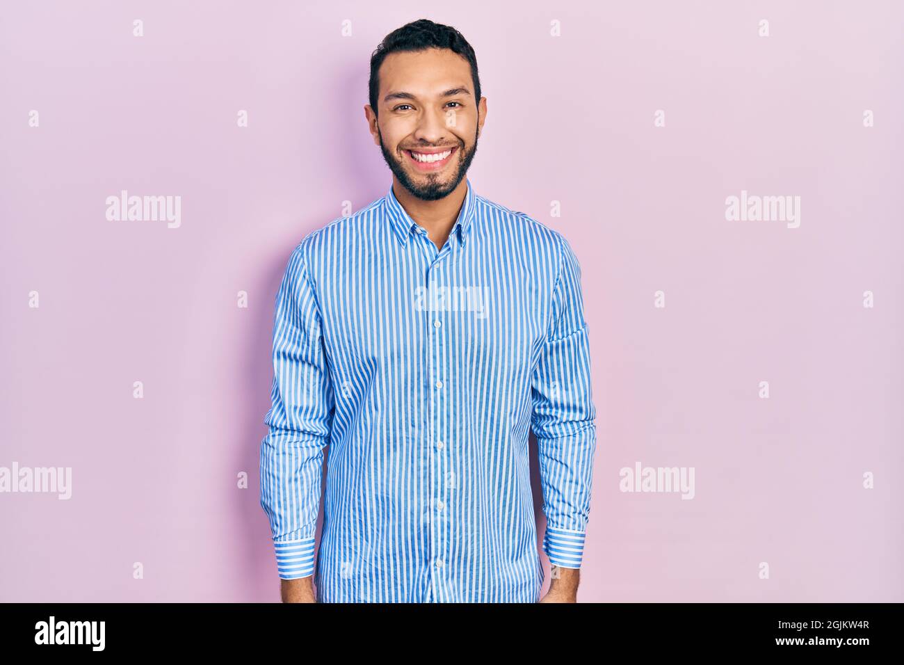 Hispanic man with beard wearing casual blue shirt with a happy and cool ...