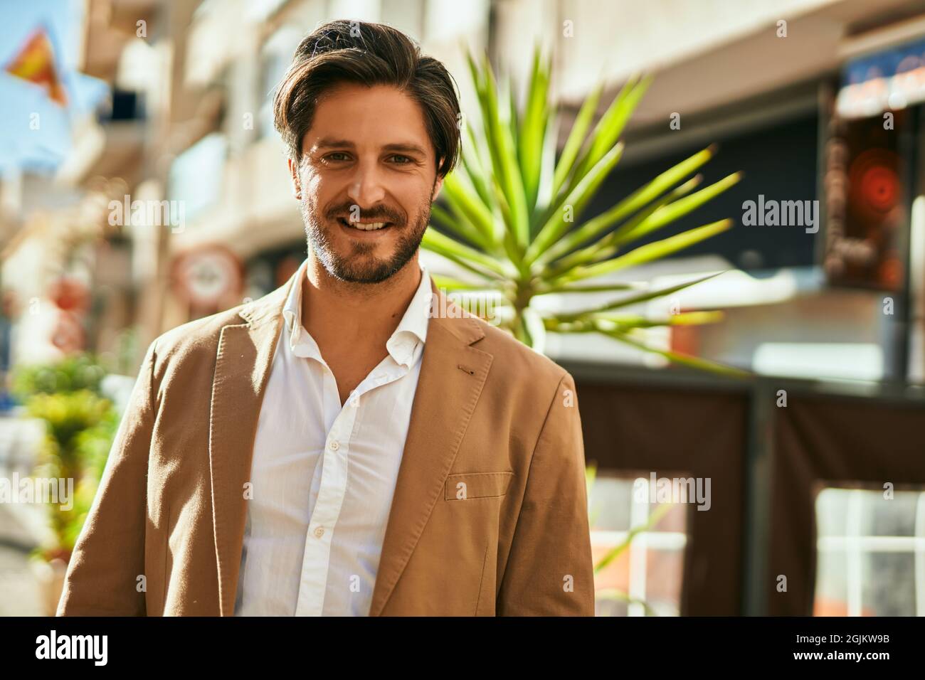 Young hispanic businessman smiling happy standing at the city Stock ...