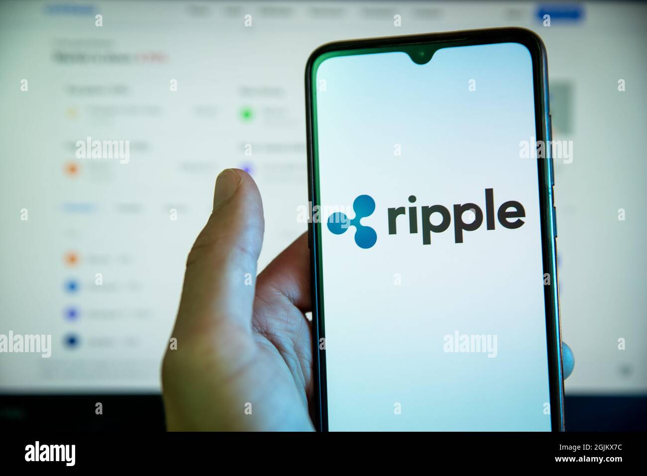 The Ripple cryptocurrency logo is seen on the display of a mobile phone ...