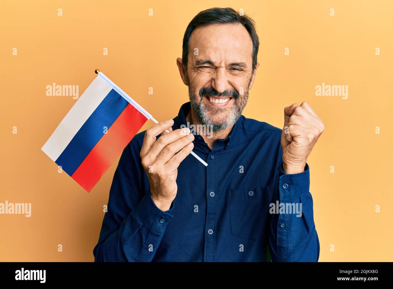 Middle age hispanic man holding russia flag screaming proud ...