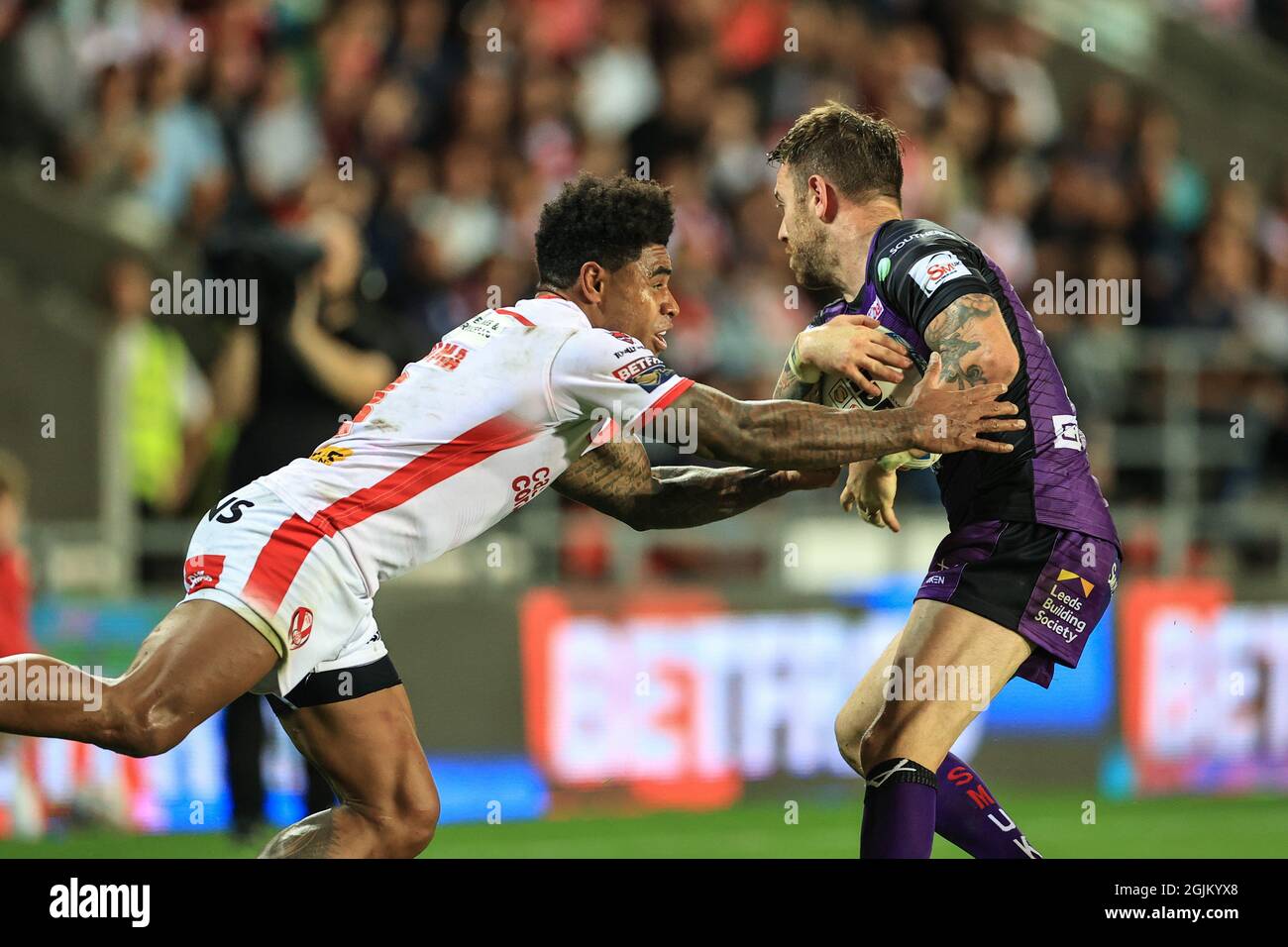 Richie Myler (16) of Leeds Rhinos and Kevin Naiqama (3) of St Helens ...