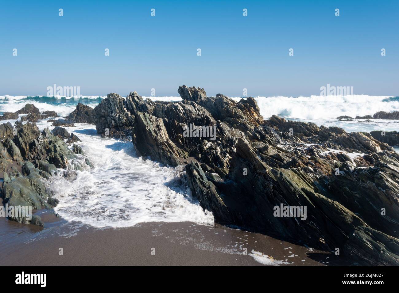 Closeup shot of sea waves beautifully touching the rocks Stock Photo ...