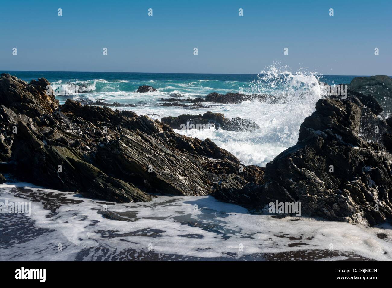 Closeup shot of sea waves beautifully touching the rocks Stock Photo ...