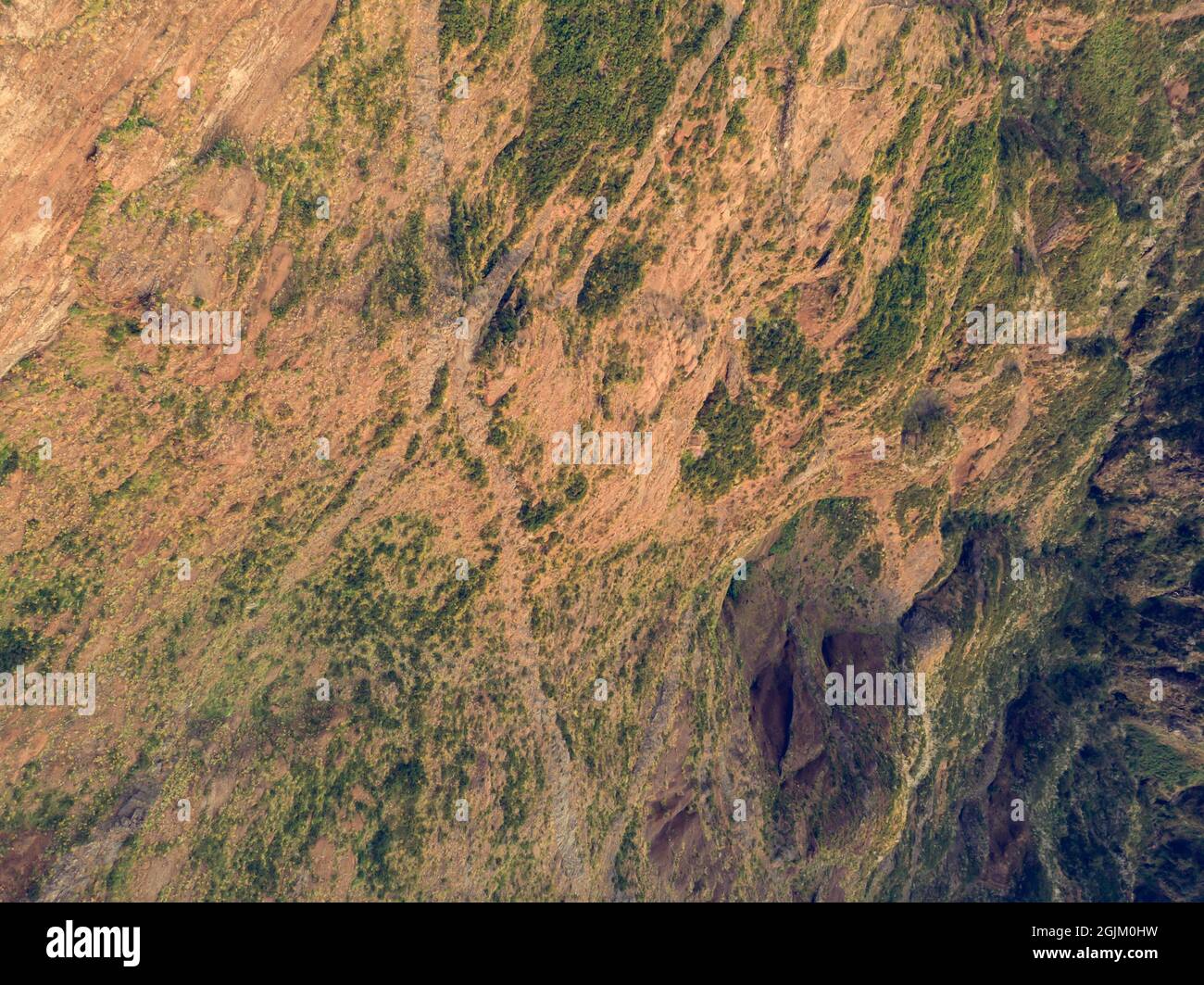 Drop down view of spectacular volcanic landscape with magma layers ...