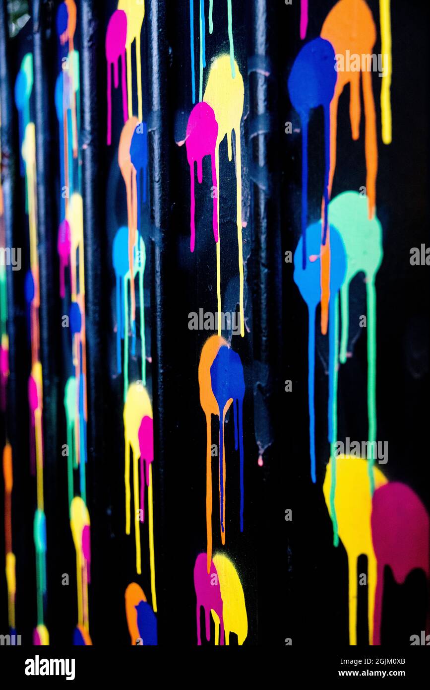 Vertical shot of colorful paint all over a black surface Stock Photo ...