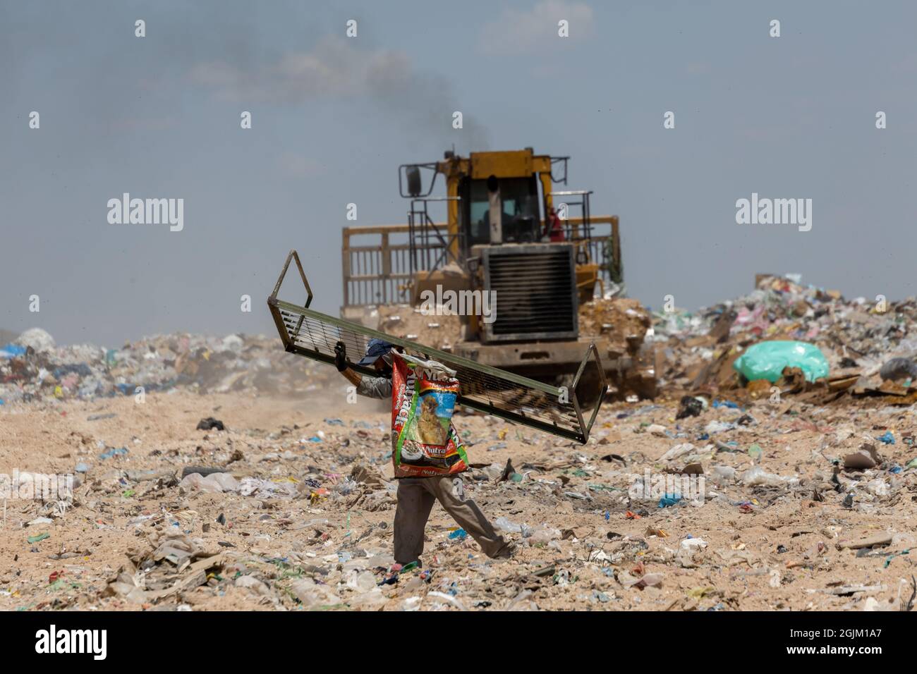 Men, women and children work as scavengers in the municipal garbage ...