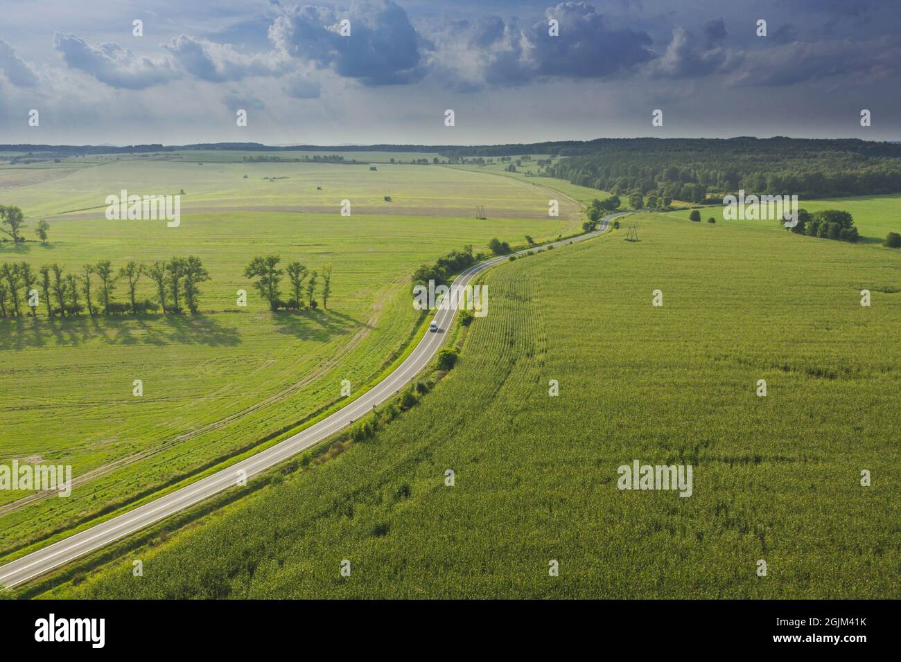 Asphalt road through farmland and meadows. View from the drone Stock ...