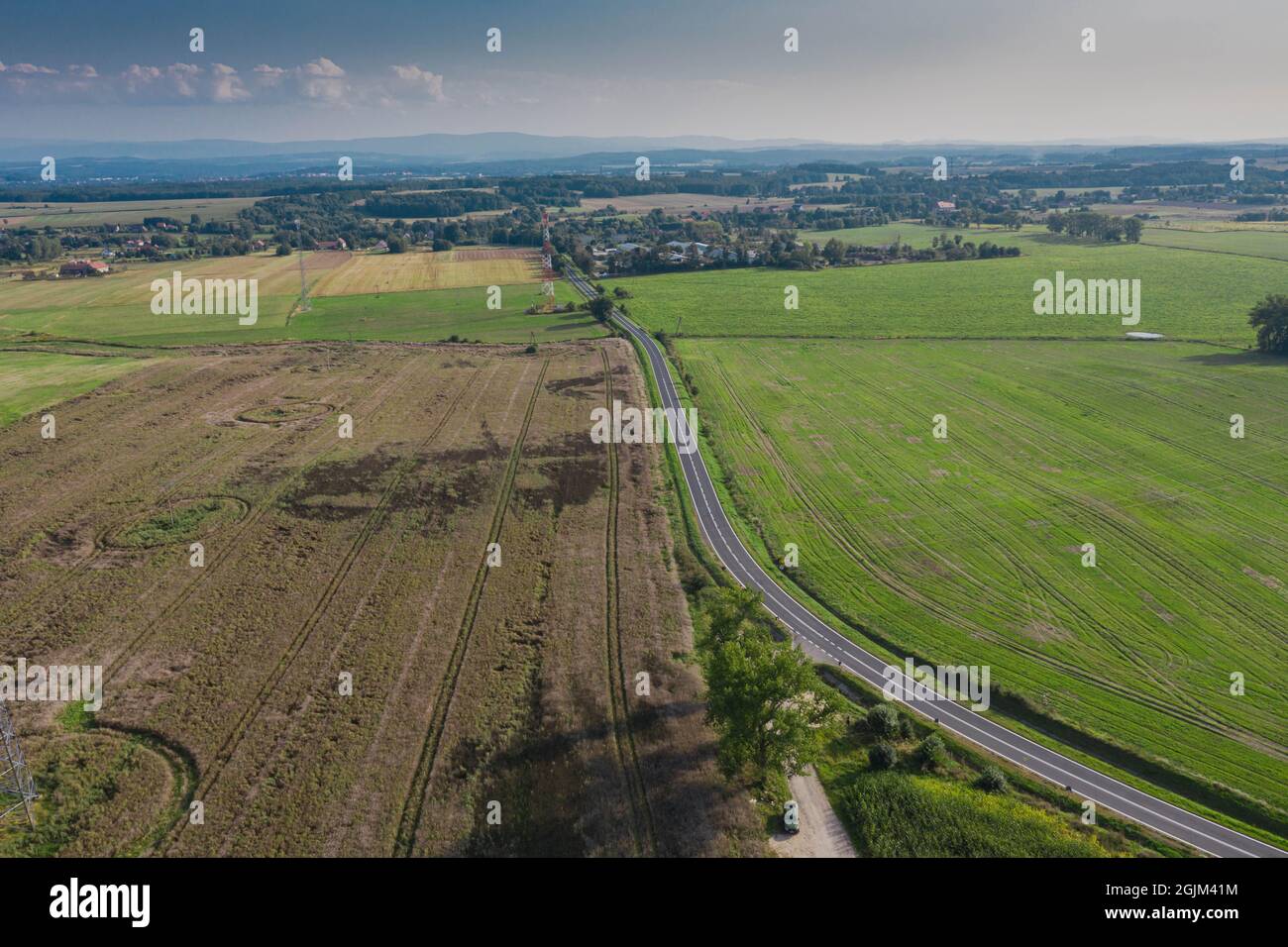Asphalt road through farmland and meadows. View from the drone Stock ...