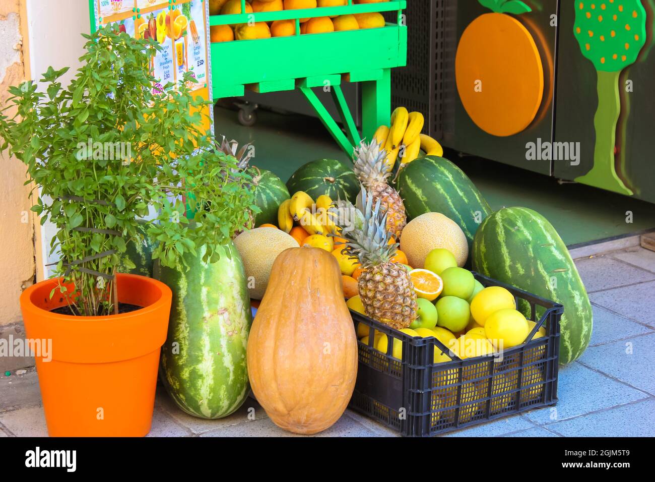 A basket of different fresh eco summer fruits stands on a street ...