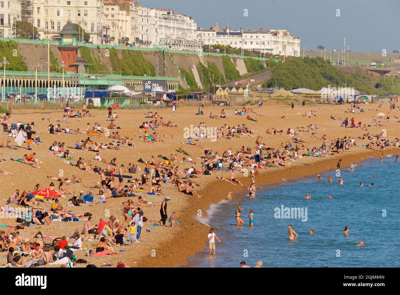 Crowded beack of Kemptown, Brighton. East of Brighton Palace Pier ...