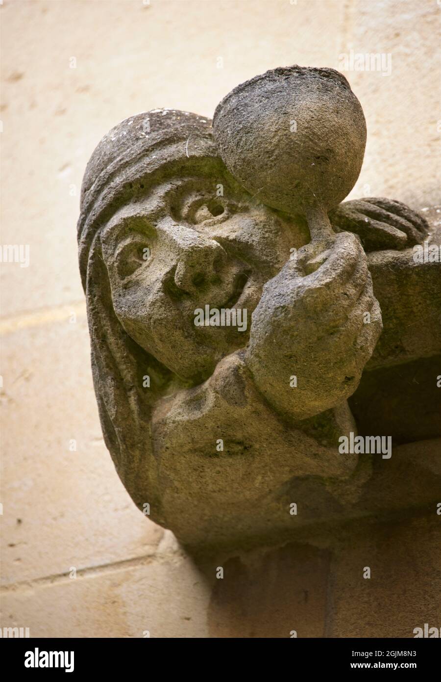 Stone carved gargoyle. Grotesque holding out a goblet .Christ Church ...