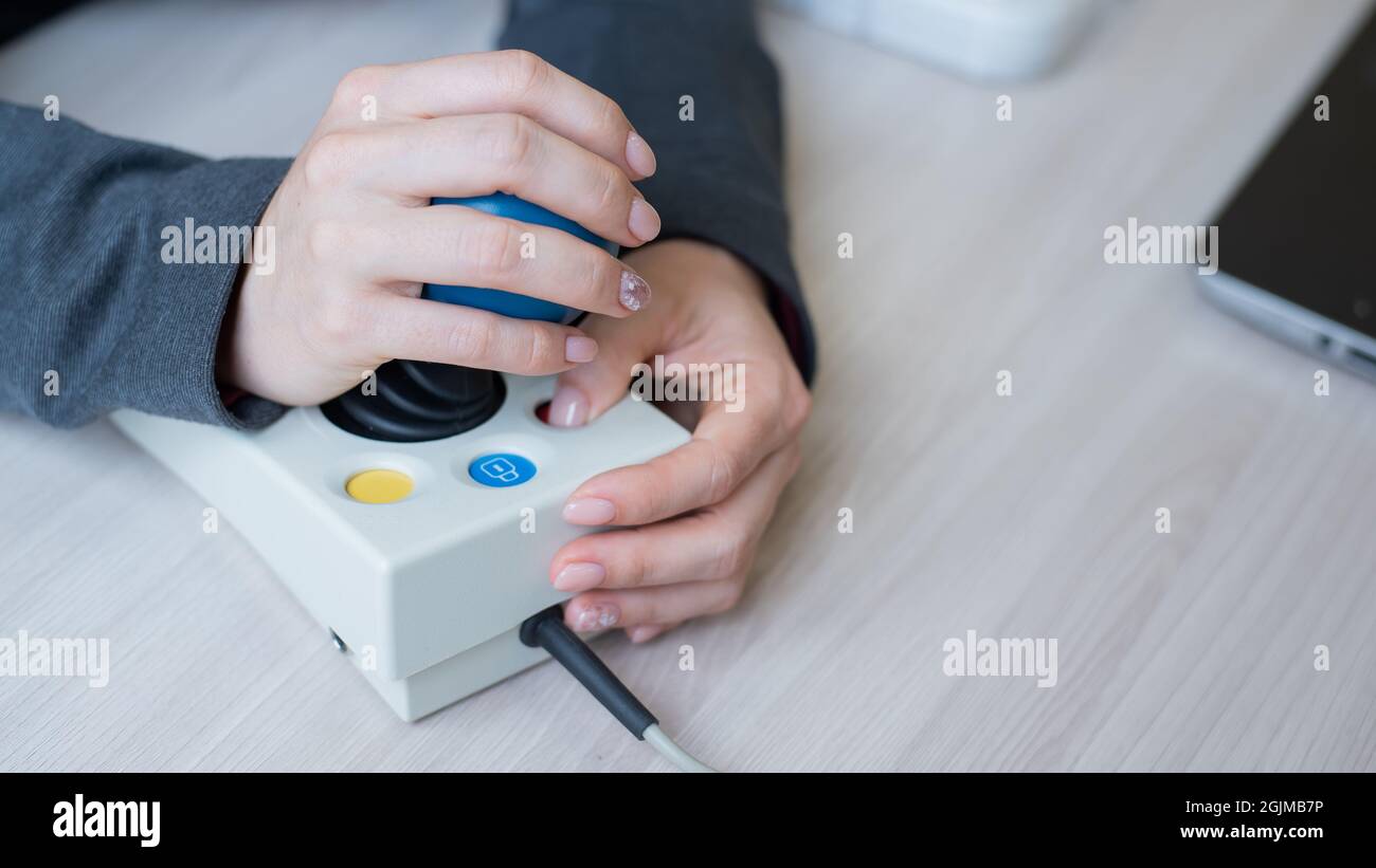 Woman with cerebral palsy works on a specialized computer mouse Stock ...