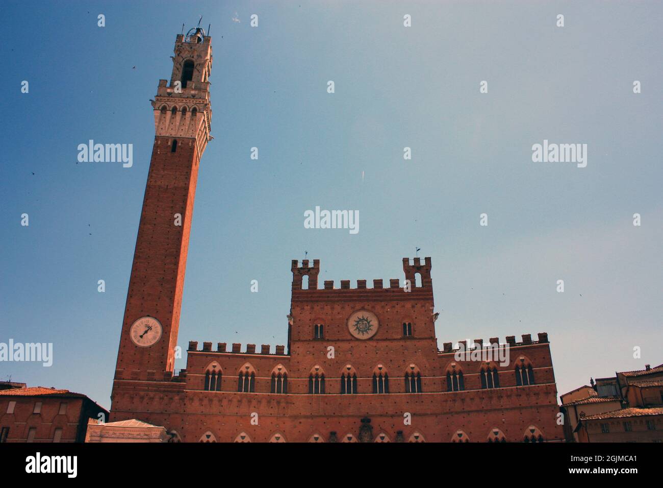 the medieval Piazza del Campo di Siena and the red civic tower of the ...