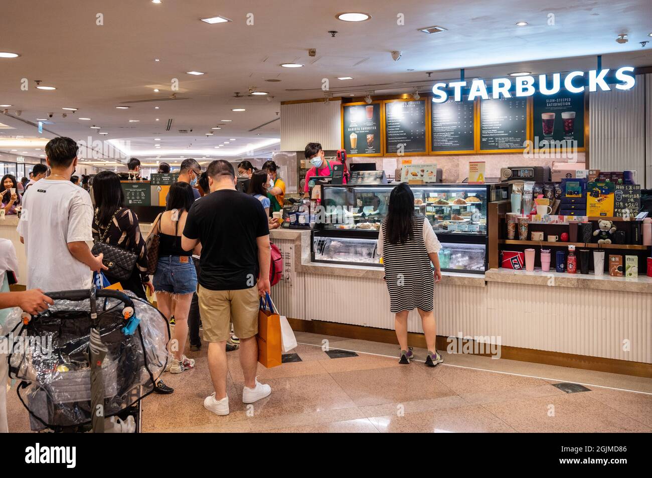 Customers queue at the American multinational chain Starbucks Coffee ...
