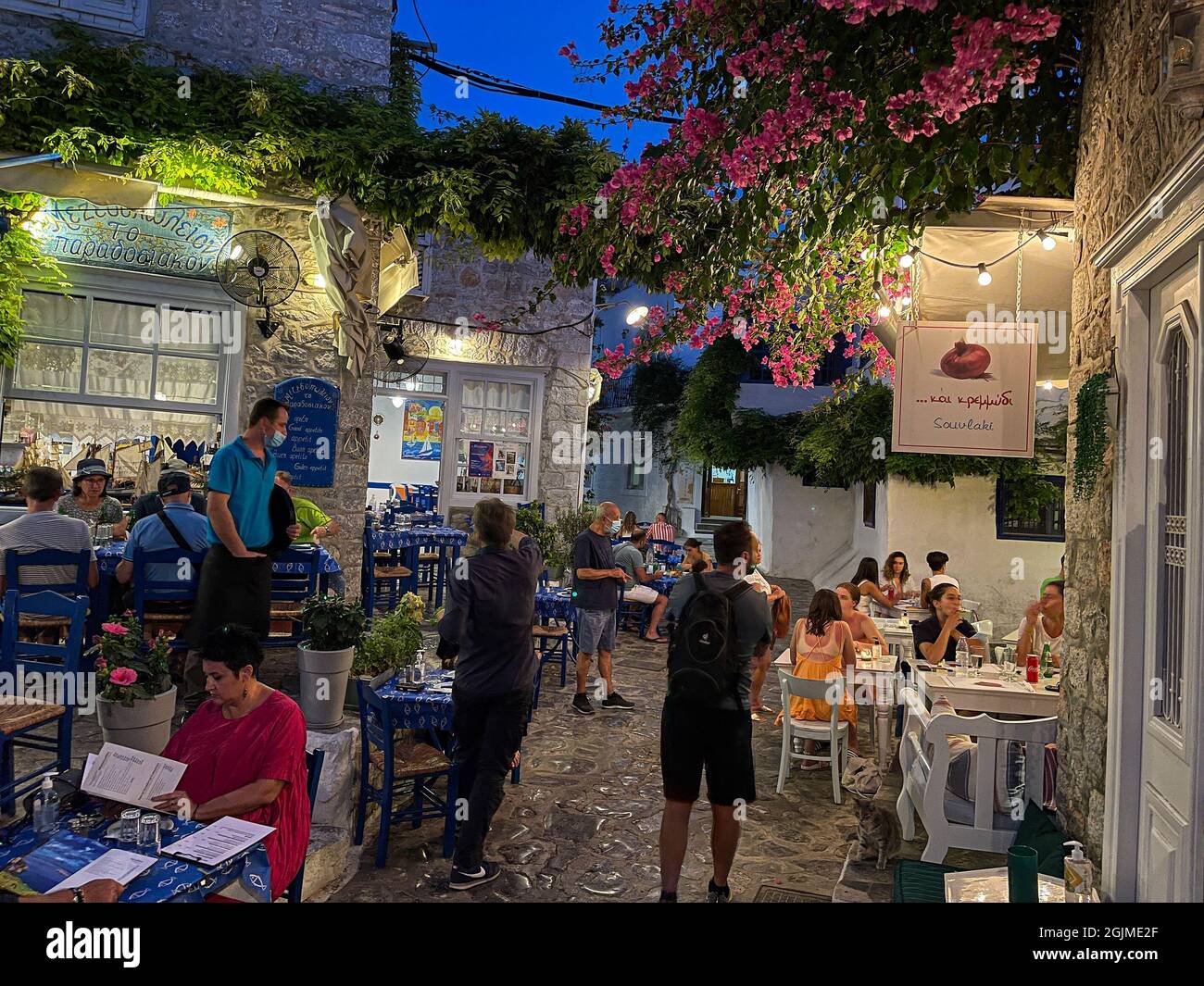 Pedestrian streets of Hydra island at night. View of the center of ...