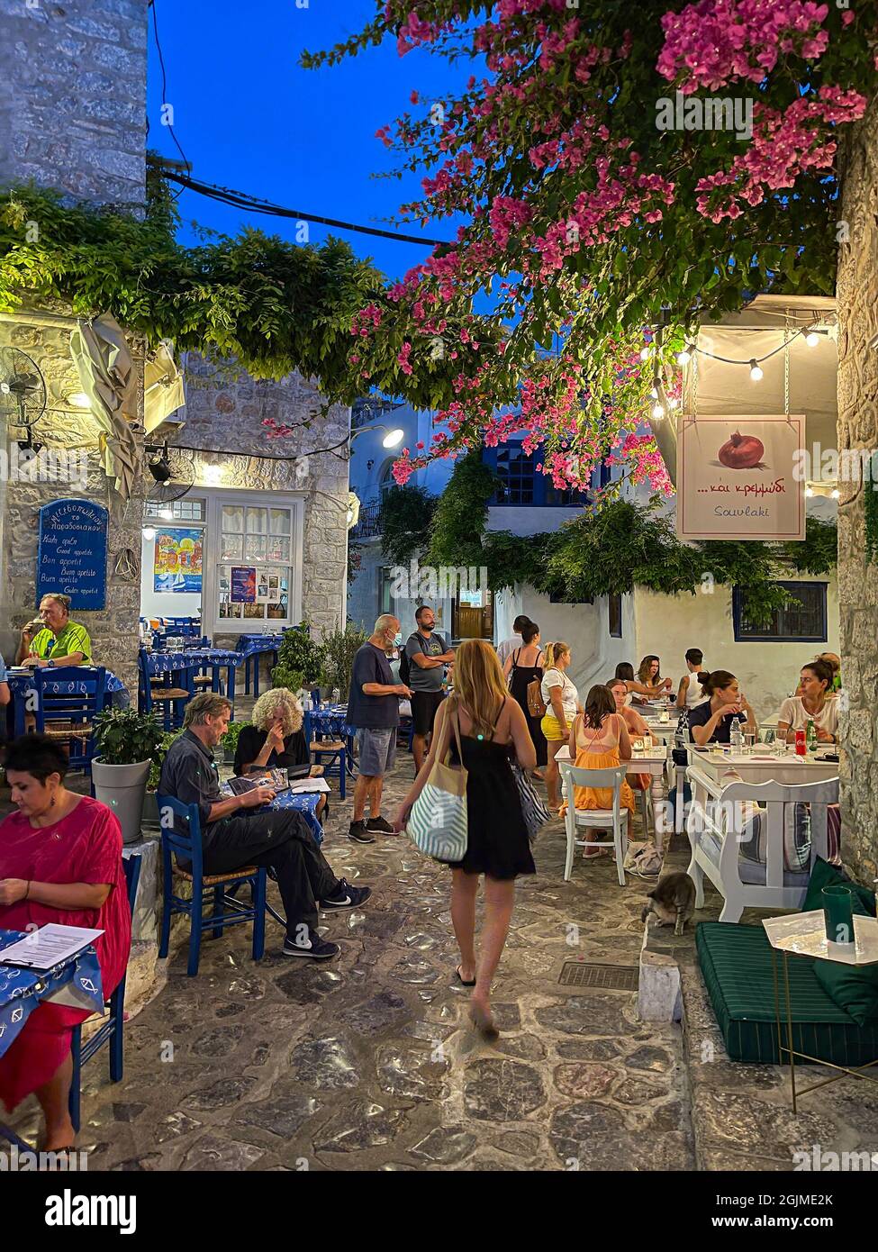 Pedestrian streets of Hydra island at night. View of the center of ...
