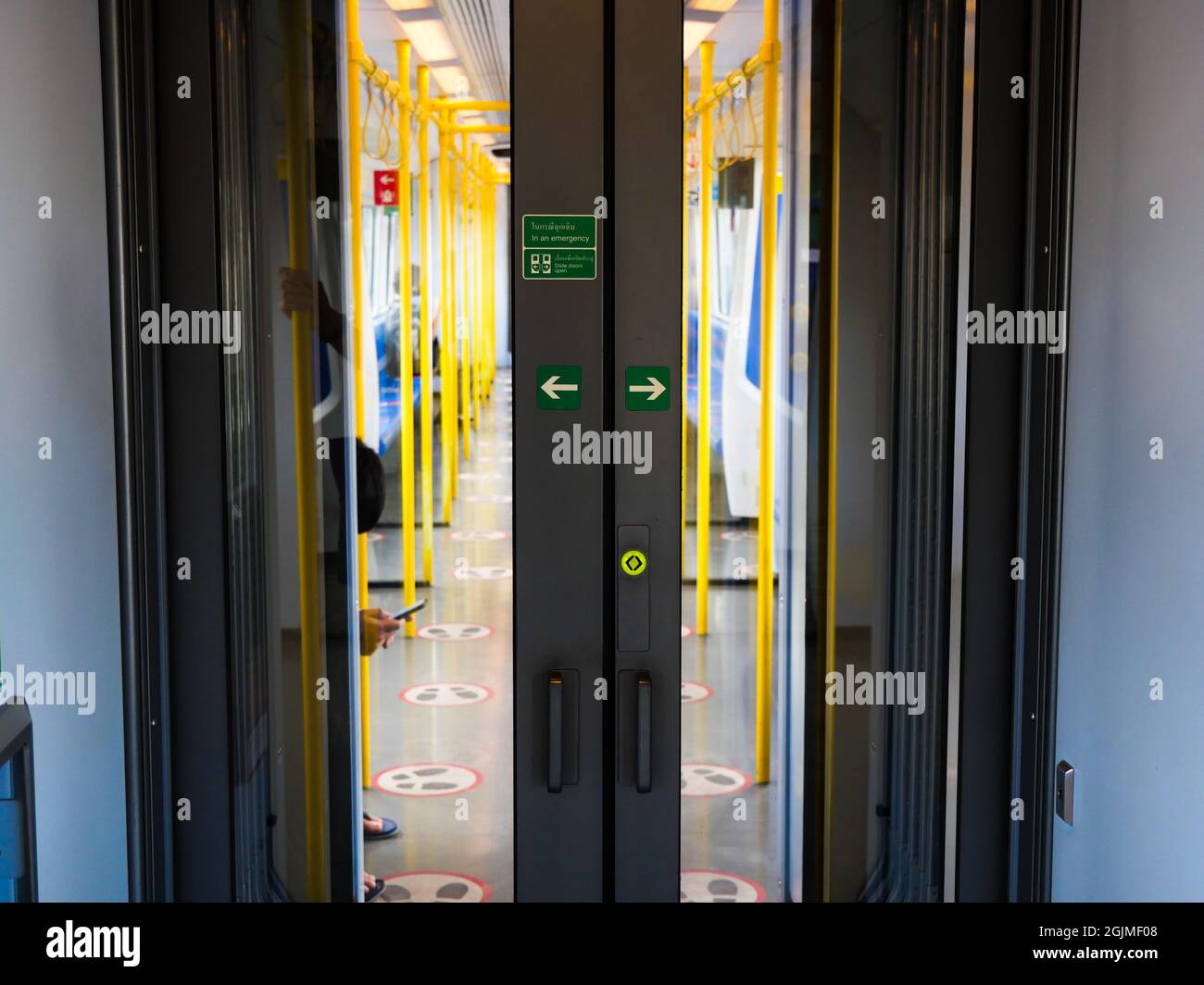 The doors in the trains are closing. while the electric train is ...