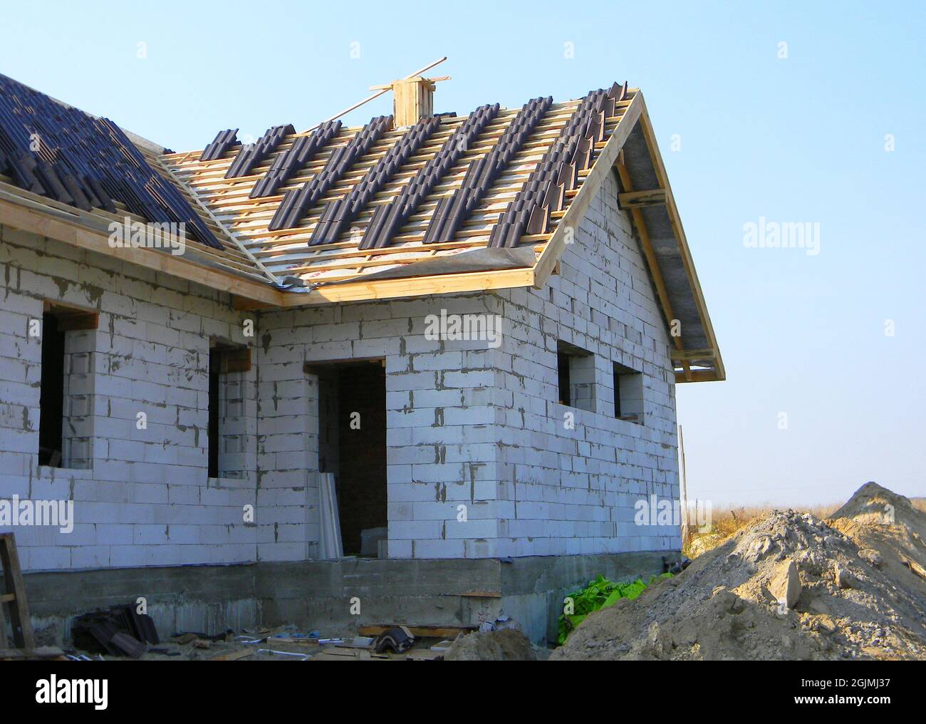 Roofing construction with clay roof tiles. Building house with ceramic ...