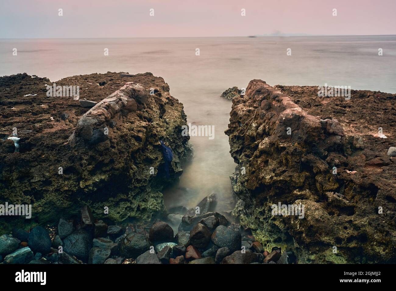 rocks on the beach with waves in the beautiful afternoon Stock Photo ...