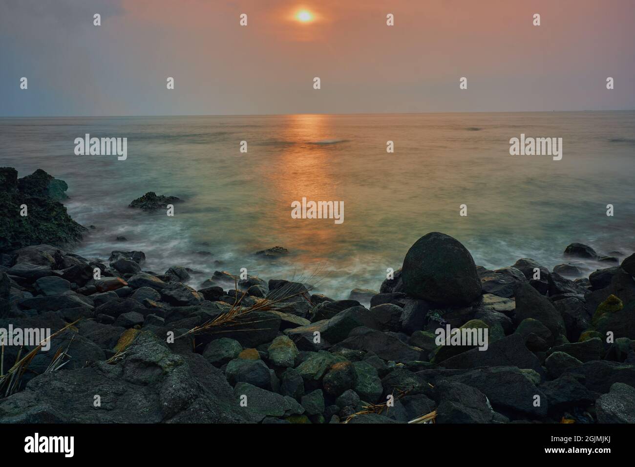 rocks on the beach with waves in the beautiful afternoon Stock Photo ...