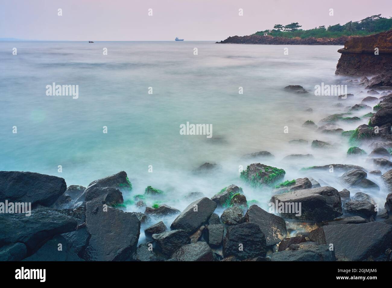 rocks on the beach with waves in the beautiful afternoon Stock Photo ...