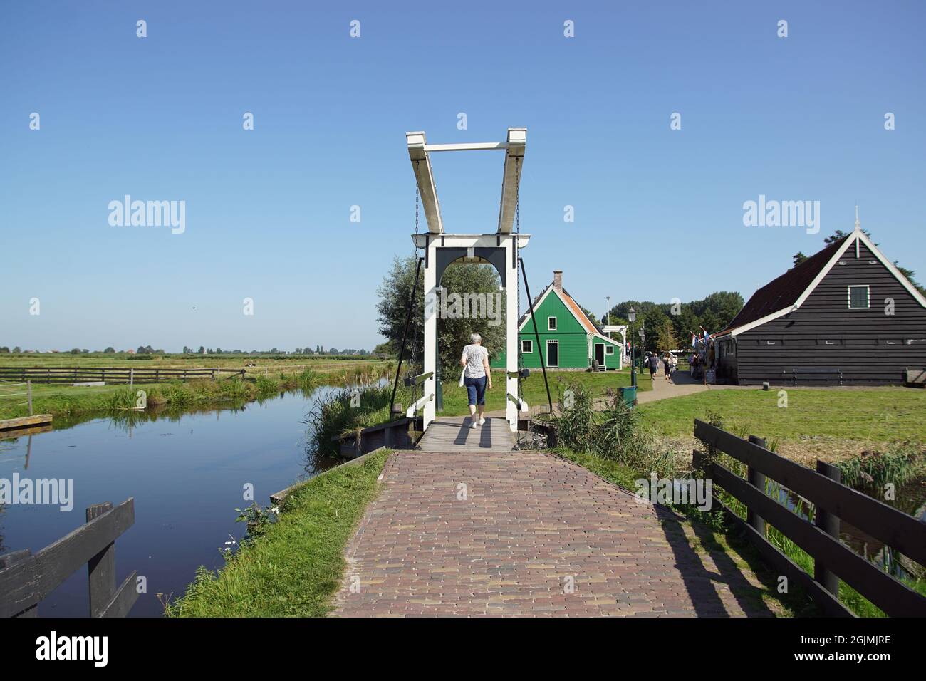 Small, white, old drawbridge with old Zaanse houses of the Dutch open ...