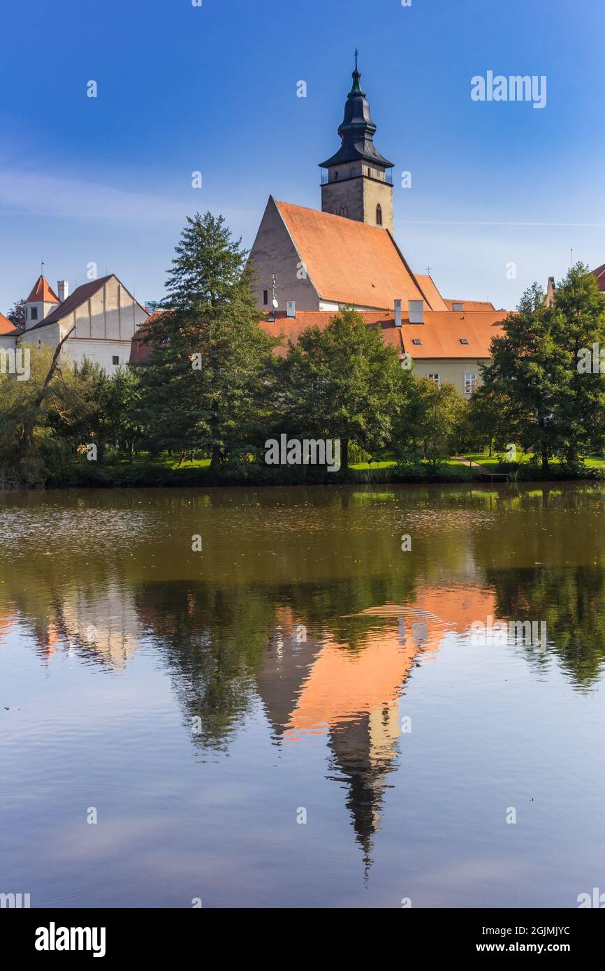 Church tower reflected in the lake in Telc, Czech Republic Stock Photo ...