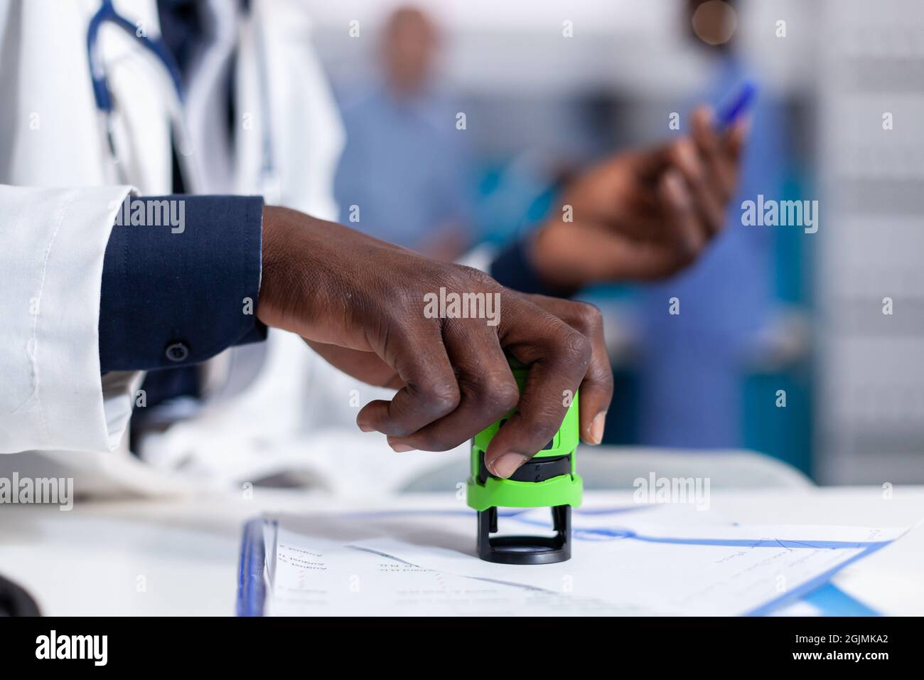 Close up of african american hand holding stamp on papers for checkup ...