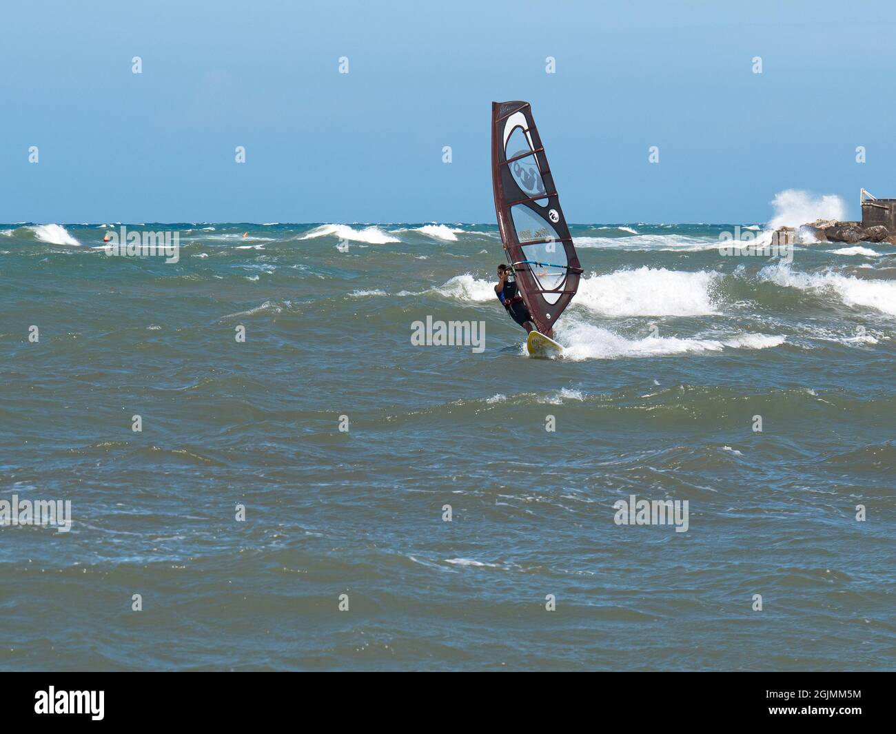 Windsurf Riding the Waves in a Choppy Sea Stock Photo - Alamy