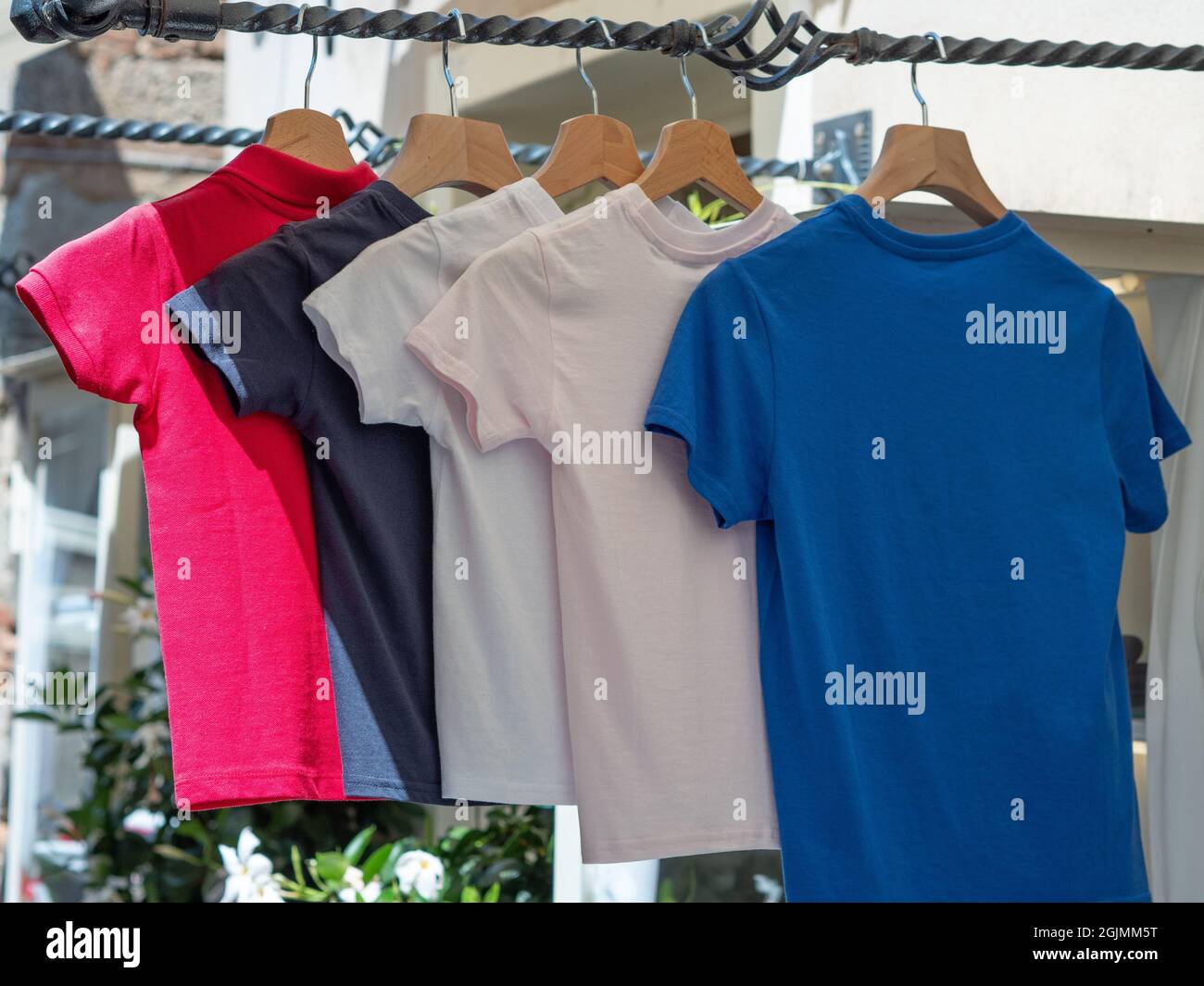 Group of Coloured T-shirts for Children Hanging outside of a Clothing ...