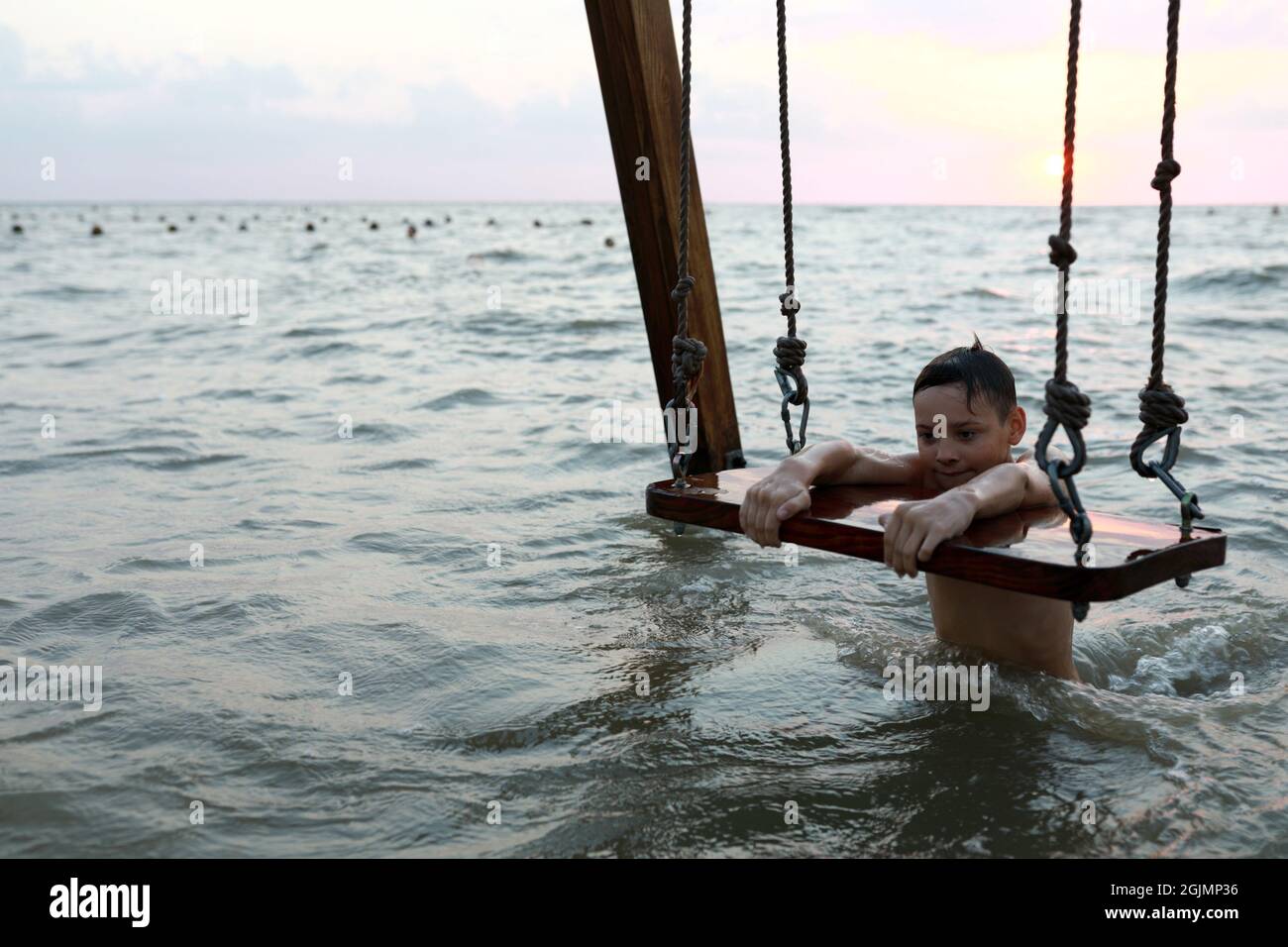 Beautiful boy swinging on swing hi-res stock photography and images - Alamy