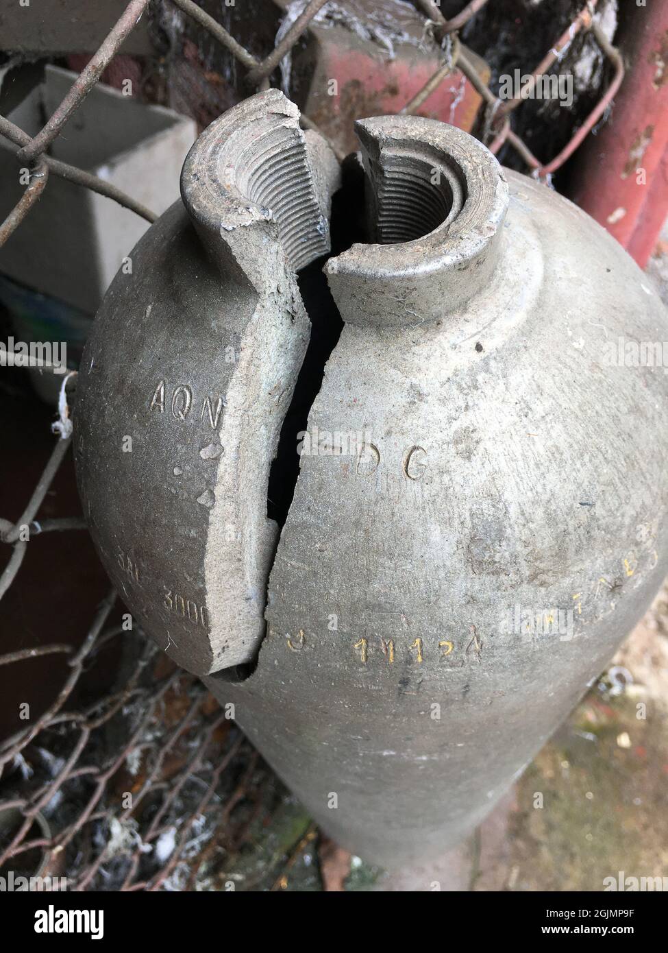 Vertical shot of an old ancient antique partly broken jug outdoors ...