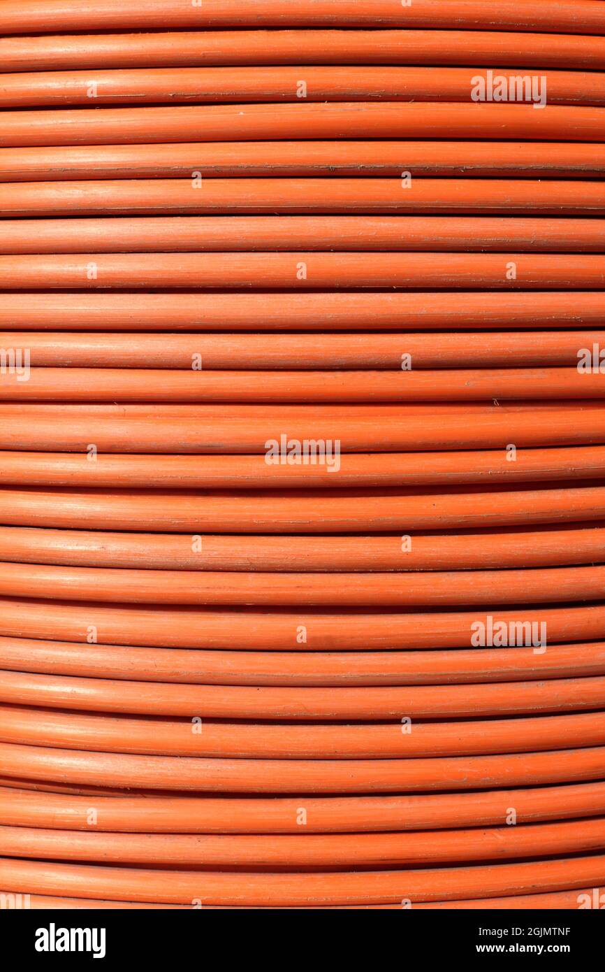 It is bunch of orange cable as background Stock Photo - Alamy