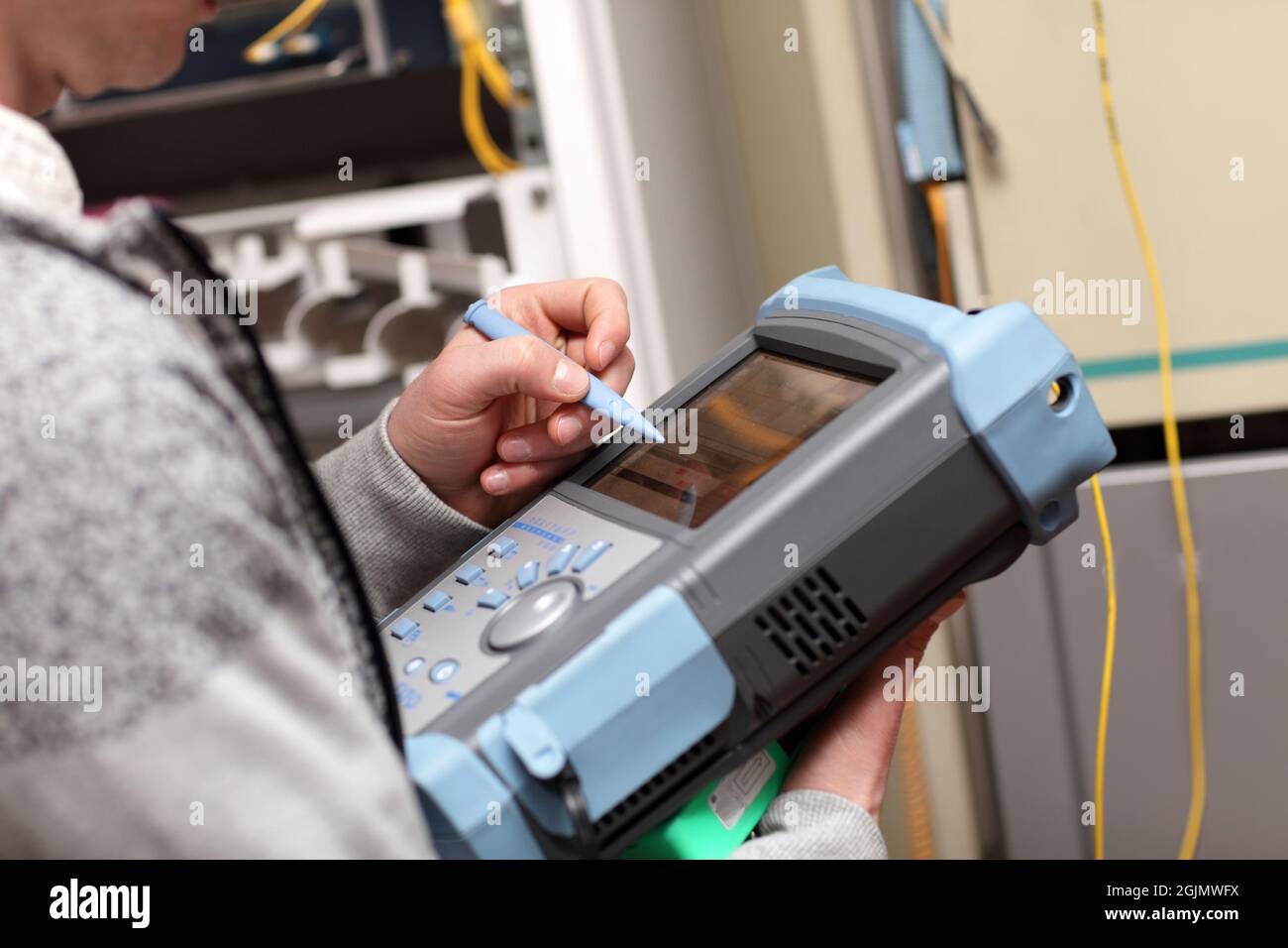 The maintenance technician measuring fibre optic in telecom site Stock ...